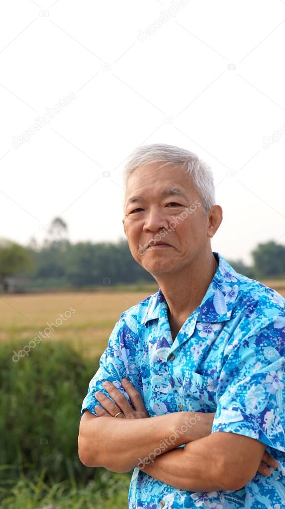 Asian man in front of rice field Stock Photo by ©glowonconcept 77312492
