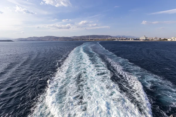 Ocean wake from cruise ship, with Greek Island on the background Stock ...