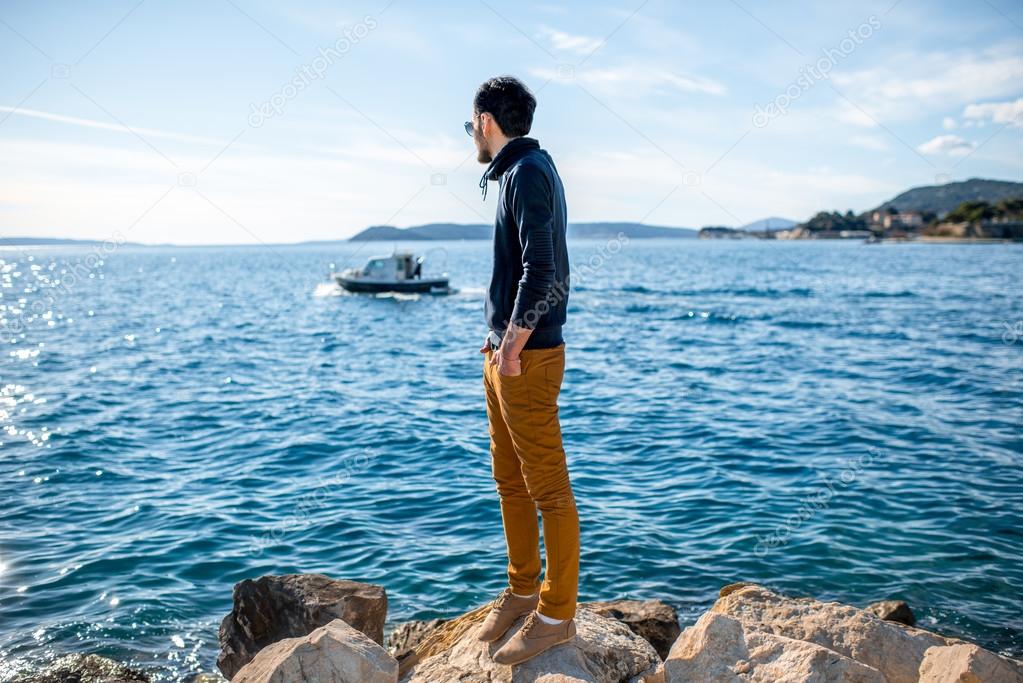 Man watching boat on the sea — Stock Photo © rossandhelen #66886305