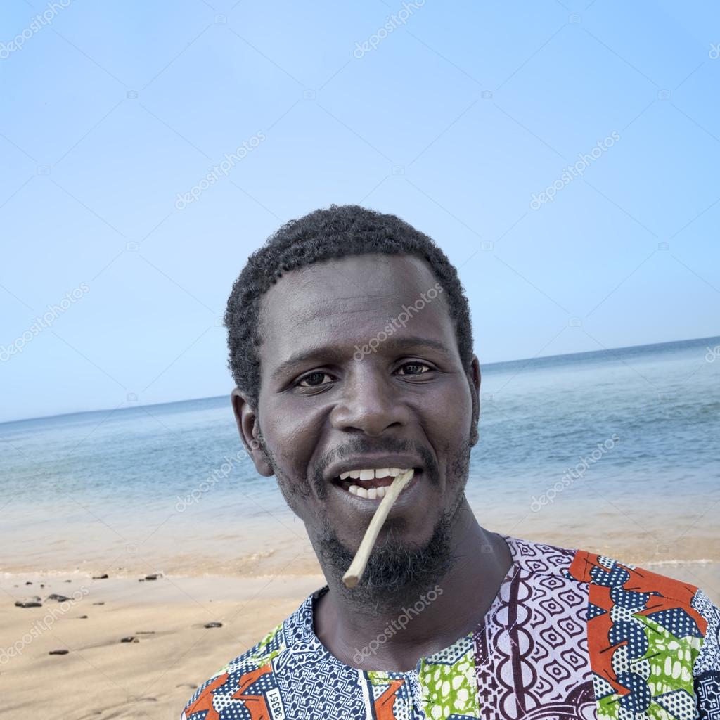 African man holding a miswak (traditional teeth cleaning twig) — Stock ...