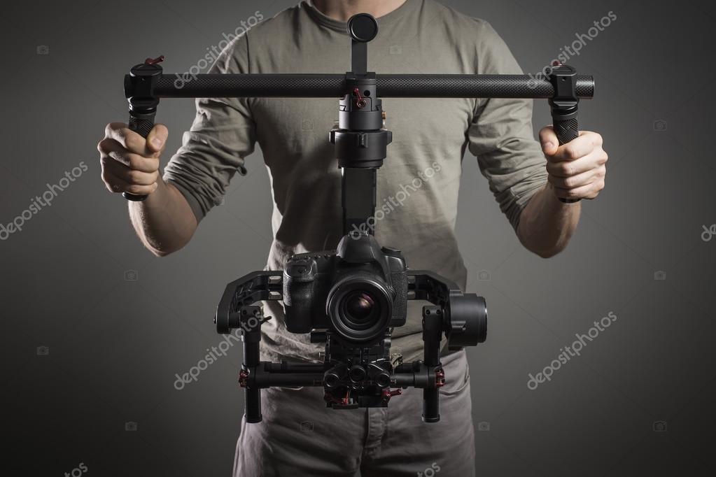 Professional videographer with gimball video slr Stock Photo by ©kor ...