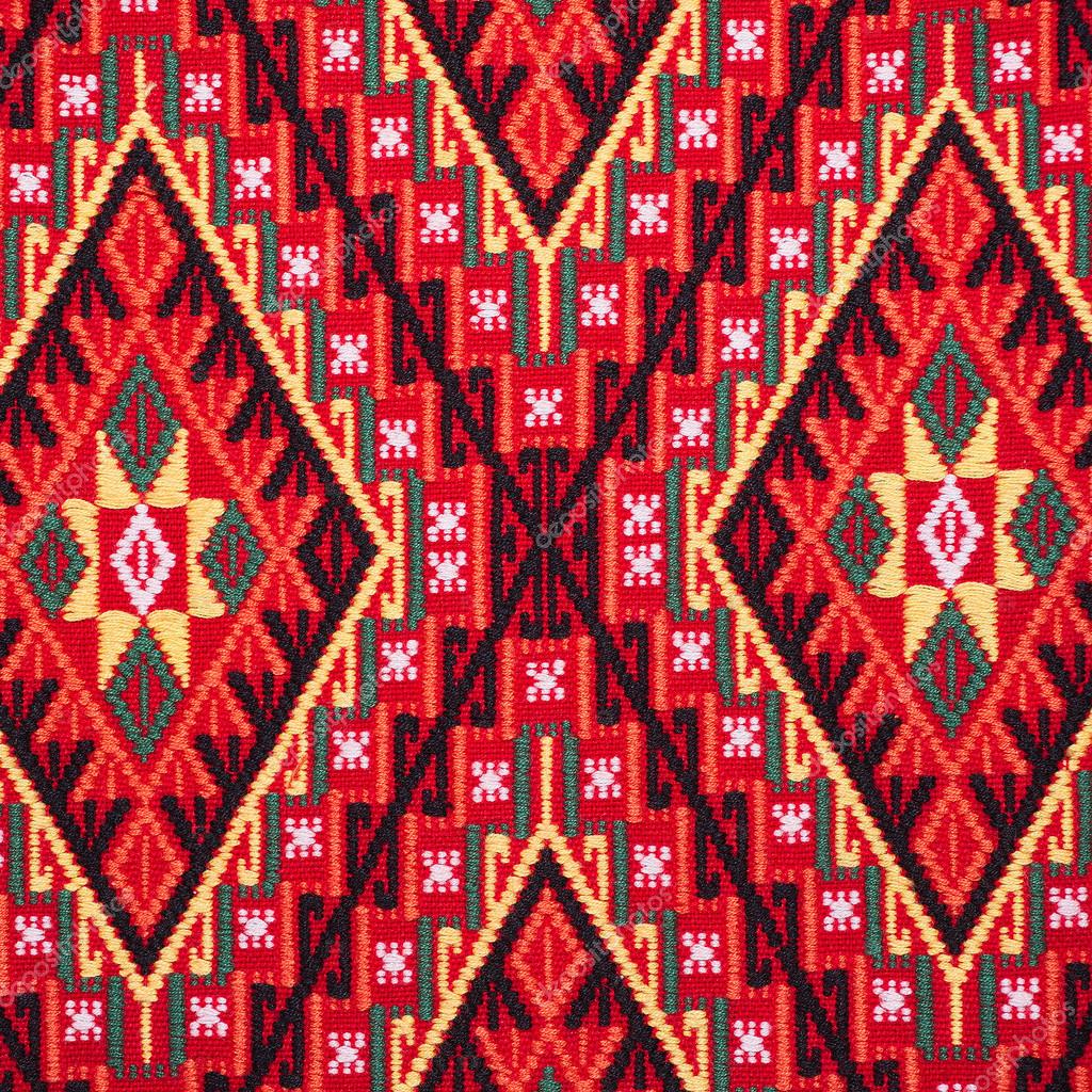 Colorful thai handcraft peruvian style rug surface close up. More of ...