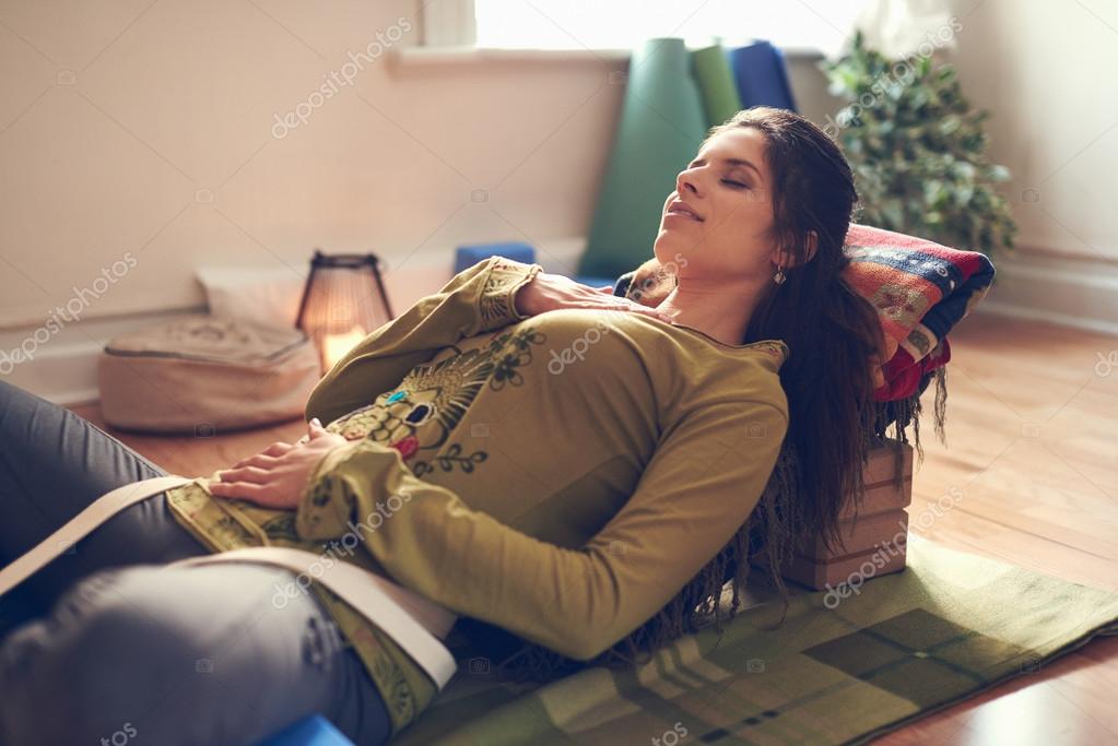 Attractive mixed race woman doing restorative yoga — Stock Photo ... Attractive mixed race woman doing restorative yoga — Stock Photo ...
