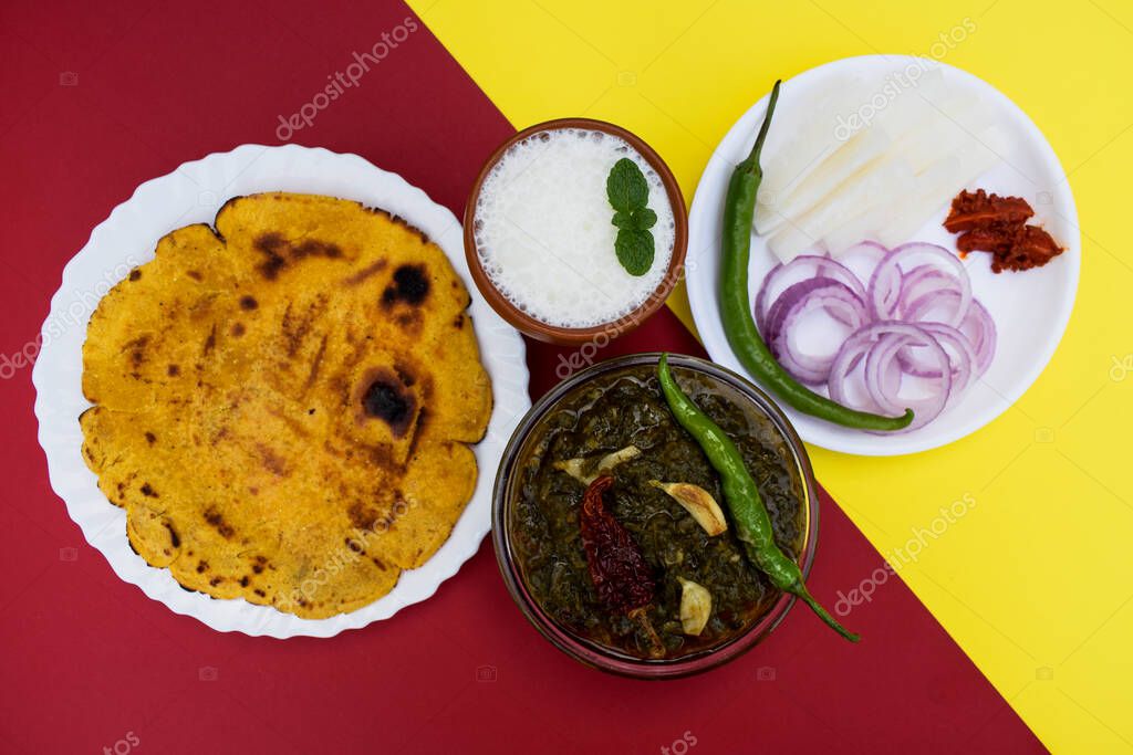 India Makki roti y Sarson saag con ensalada de cebolla fría y vaso de ...