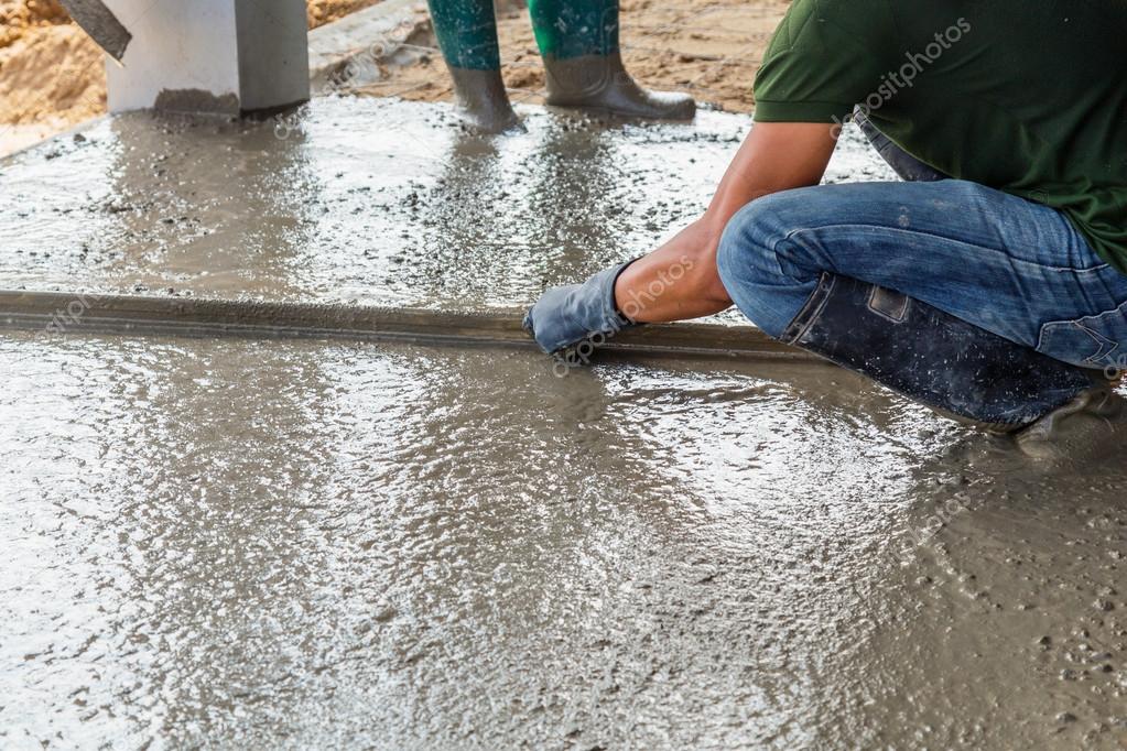 Man mason building a screed coat cement on floor Stock Photo by ...