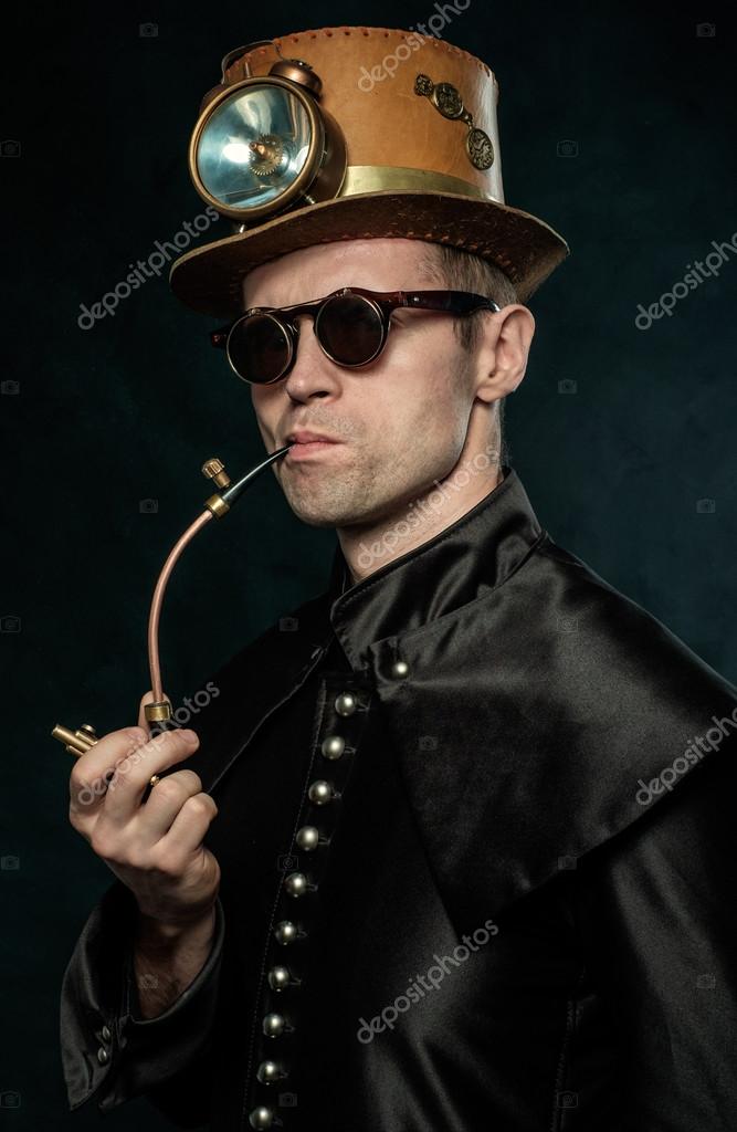 Steampunk man in a hat smoking a pipe. Stock Photo by ©fotoatelie 108288428