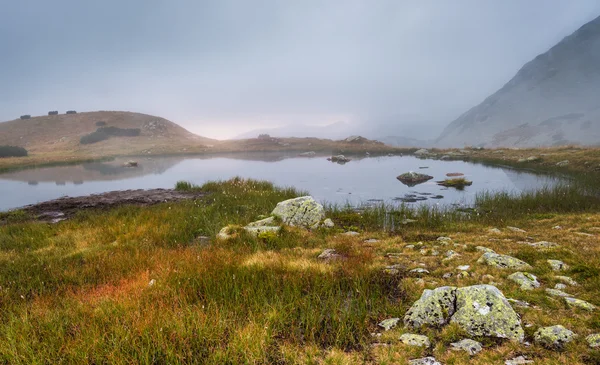 Small Tarn with Rocks in Foggy Mountains Stock Photo by ©Kayco 110983880