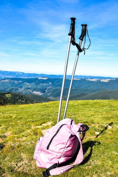 Trekking poles at top of mountain with beautiful view of autumn ...