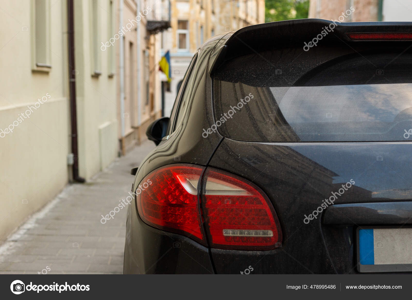 Back window of black car parked on the street in summer sunny day, rear ...