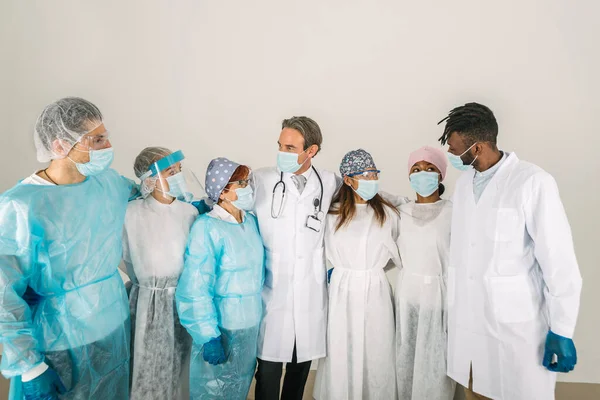 Team of doctors and nurses wearing disposable protection suits and face ...