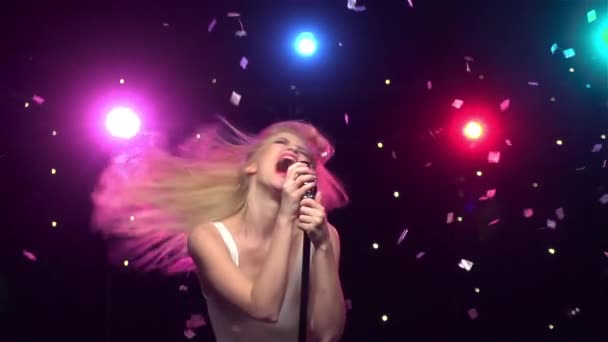 Girl singing and dancing with retro microphone strobe lighting effect ...