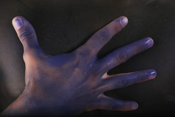 Body art tinted black man's hands on the background of male body ...