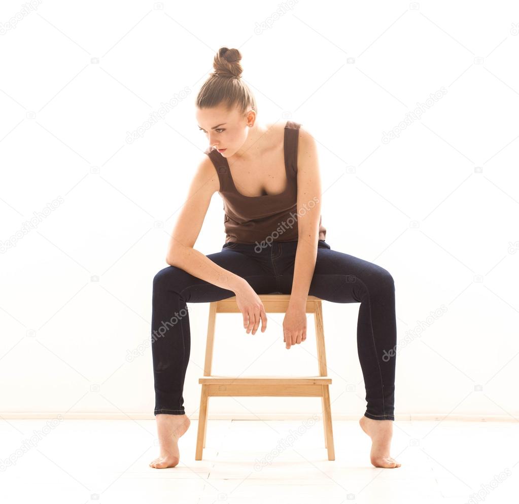 Attractive young woman sitting on chair — Stock Photo © kiraliffe #61855473