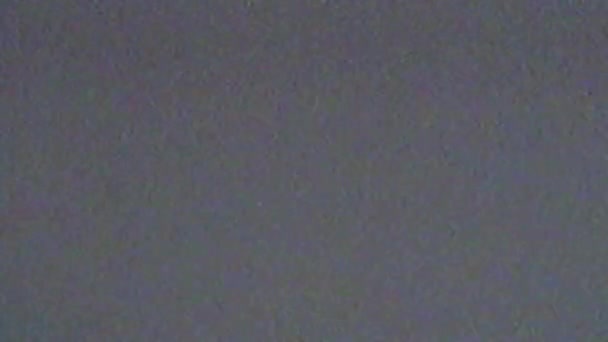 VHS shaking, flickering, defects, noise and artifacts on gray TV screen ...