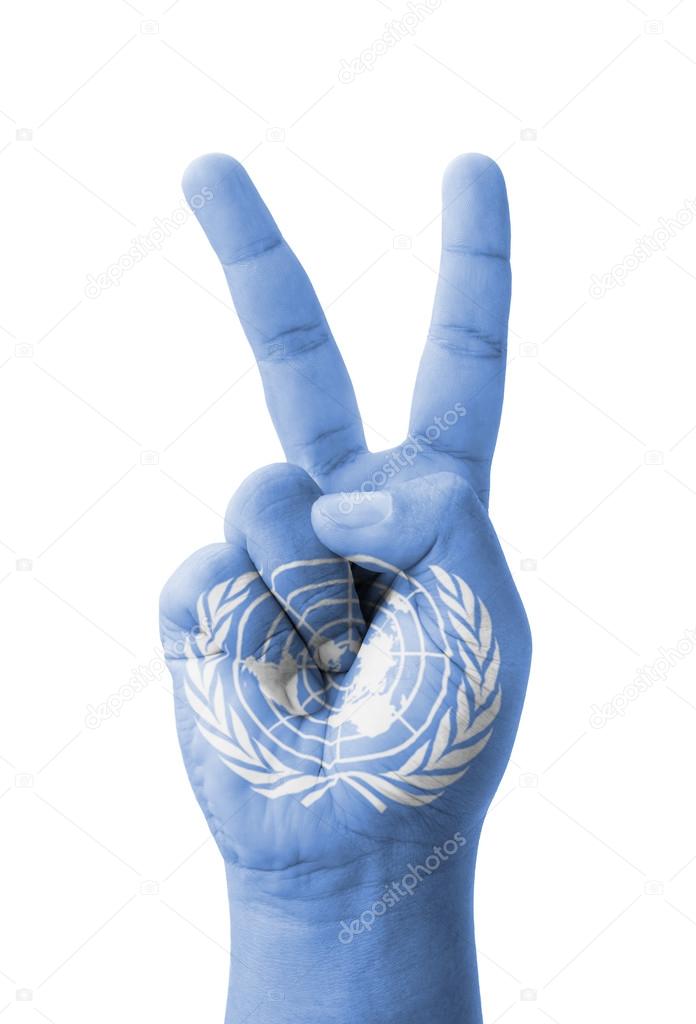 Hand making the V sign, UN (United Nations) flag painted as symb ...