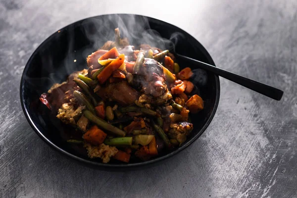 vegan roast with mixed vegetables and plant-based meatloaf slices ...