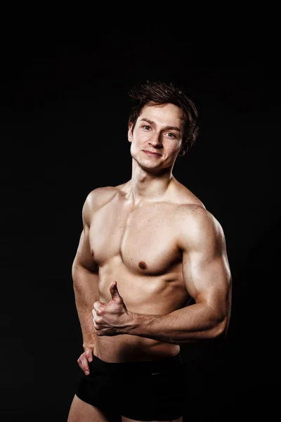 Handsome athletic man showing thumb-up in black pants. Strong bo Stock ...