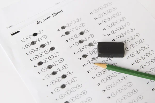 Standardized test form with answers bubbled in and a pencil, foc ...