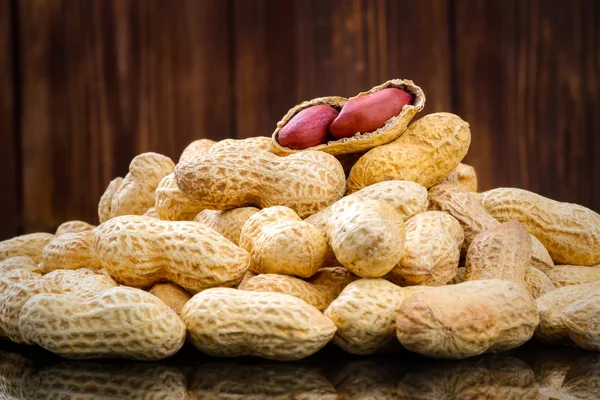 Peeled peanut on well peanuts - Stock Image - Everypixel