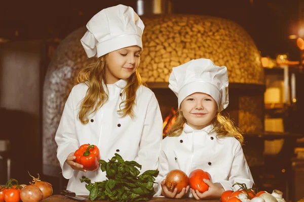 Funny happy chef girls cooking at restaurant kitchen - Stock Image ...