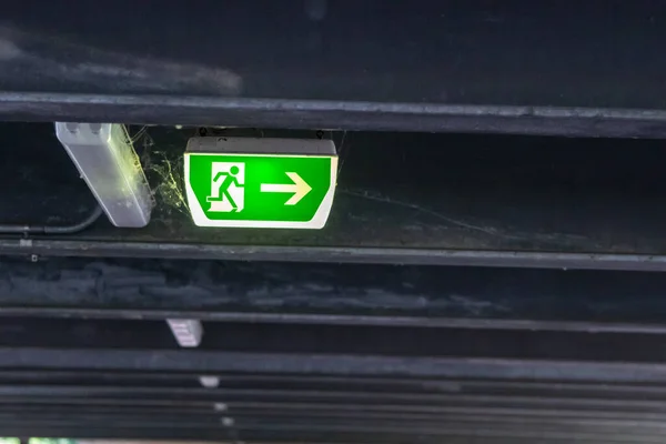 Green exit sign with running person and green arrow shows guidance ...