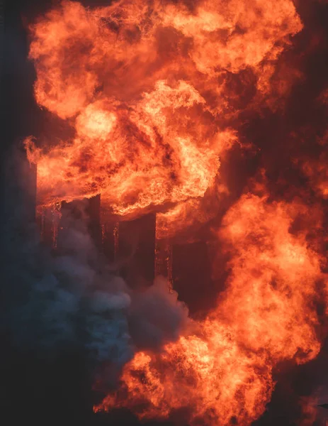 Massive large blaze fire in the city, brick factory building on fire ...