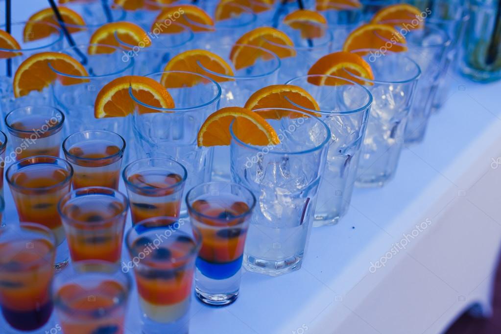 Beautiful line of different colored cocktails with smoke on a Christmas ...