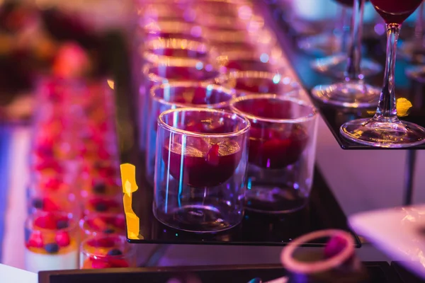 Beautiful line of different colored cocktails with smoke on a Christmas ...