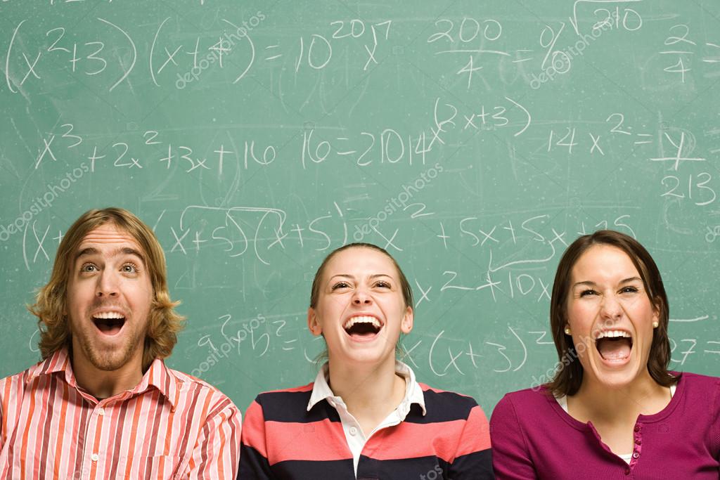 Three students laughing in classroom — Stock Photo © XiXinXing #94002118