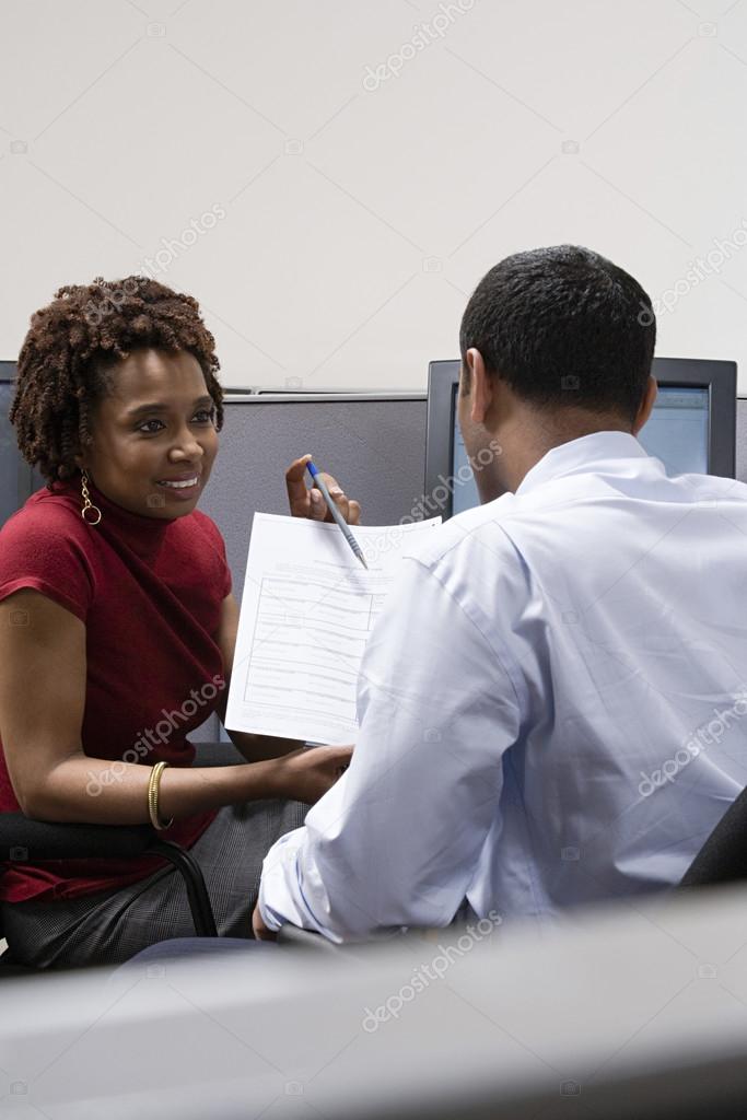Woman helping colleague with form — Stock Photo © XiXinXing #94003140