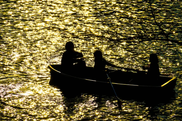 Reflection of the evening and the rowing boat silhouette - Stock Image ...