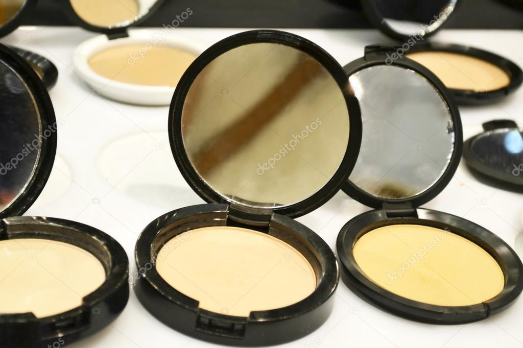 Compact pocket mirrors with a powder puff and other cosmetics Stock ...