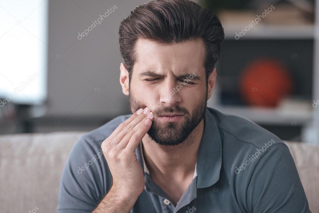 Man touching his cheek — Stock Photo © gstockstudio #100202284