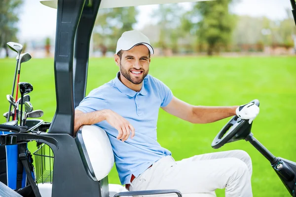 Golfer driving golf cart - Stock Image - Everypixel