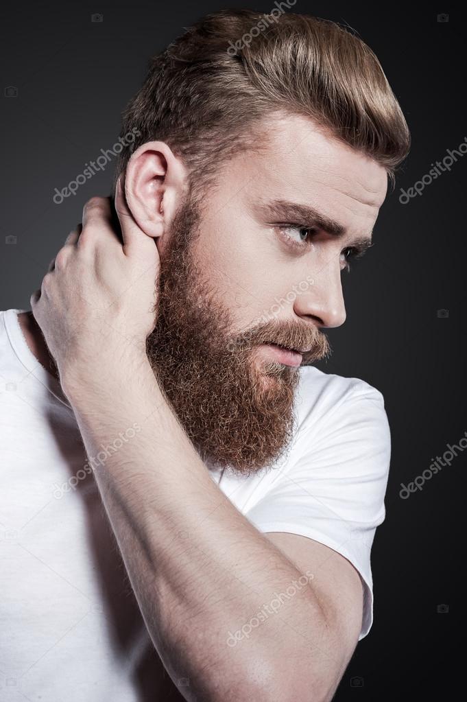 Thoughtful young bearded man — Stock Photo © gstockstudio #54827607 Thoughtful young bearded man — Stock Photo © gstockstudio #54827607
