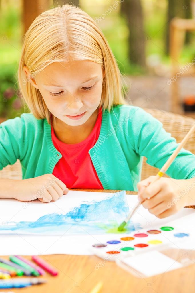 Little girl drawing something on paper Stock Photo by ©gstockstudio ...
