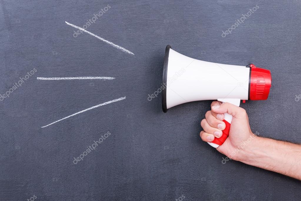 Human hand holding megaphone — Stock Photo © gstockstudio #57216291