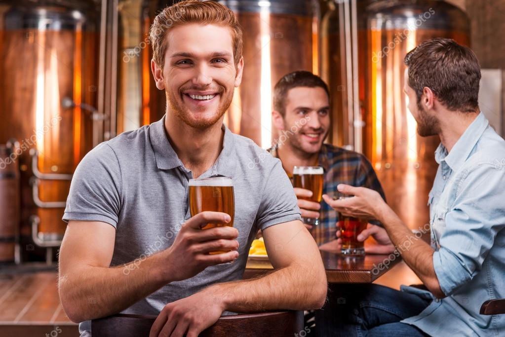 Young man toasting with beer Stock Photo by ©gstockstudio 61925401
