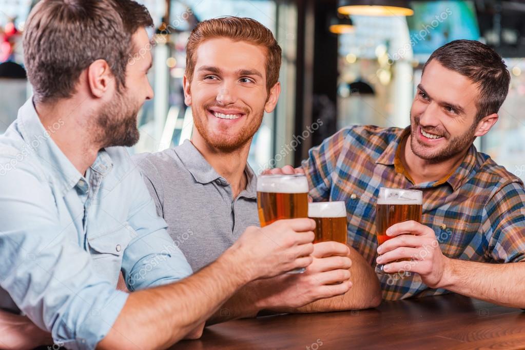 Young men drinking beer — Stock Photo © gstockstudio #61925443 Young men drinking beer — Stock Photo © gstockstudio #61925443