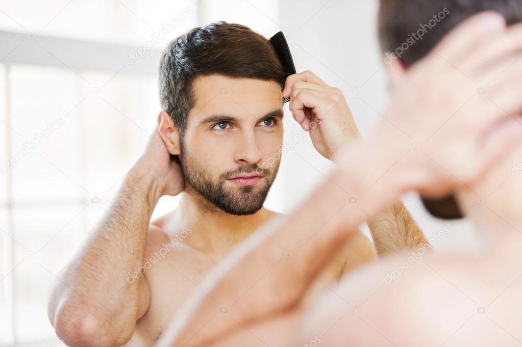 Man combing his hair — Stock Photo © gstockstudio #62790279