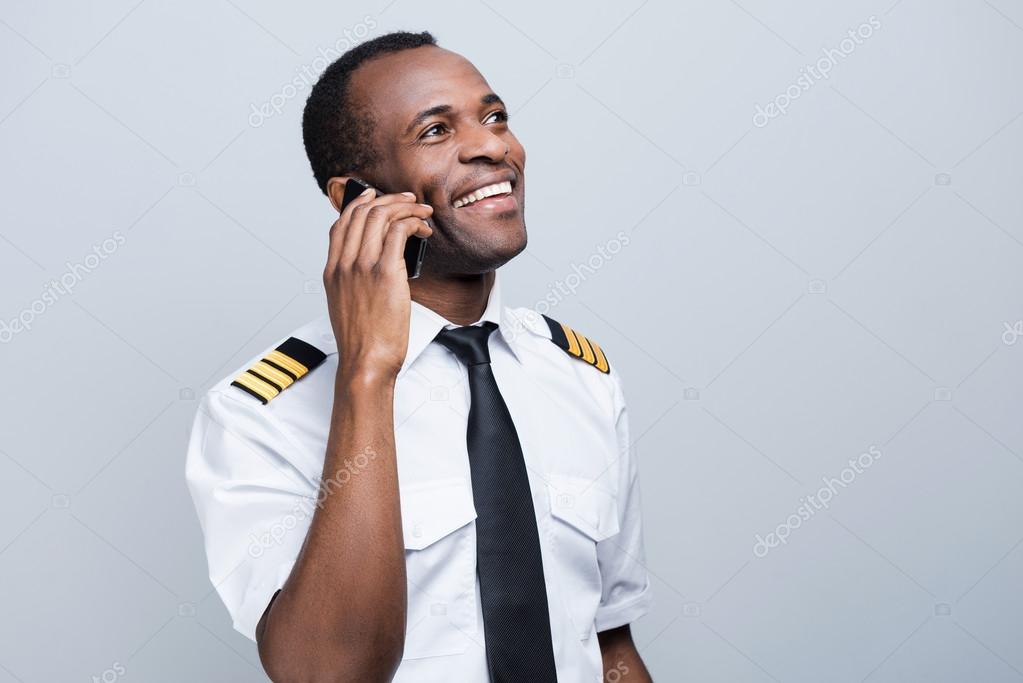 African pilot holding mobile phone Stock Photo by ©gstockstudio 65699795