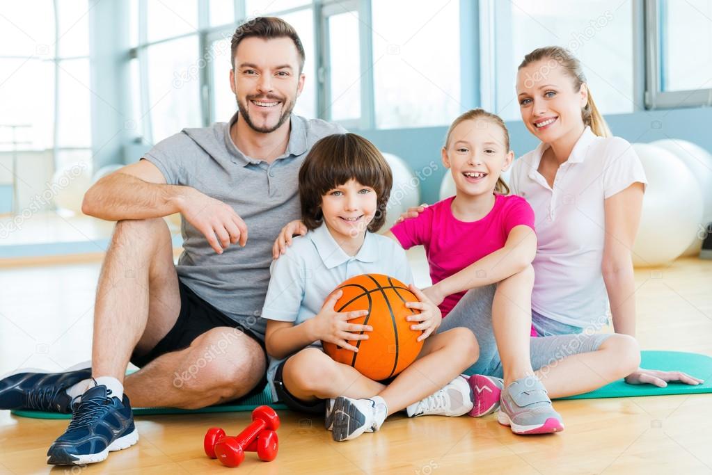 Happy sporty family in sport club Stock Photo by ©gstockstudio 68201015