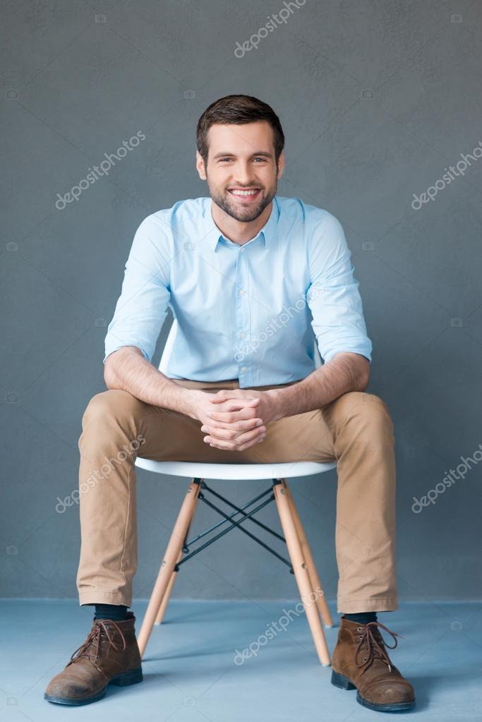 Handsome man sitting on chair Stock Photo by ©gstockstudio 70991259