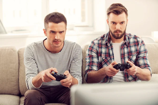 Concentrated men playing video games - Stock Image - Everypixel