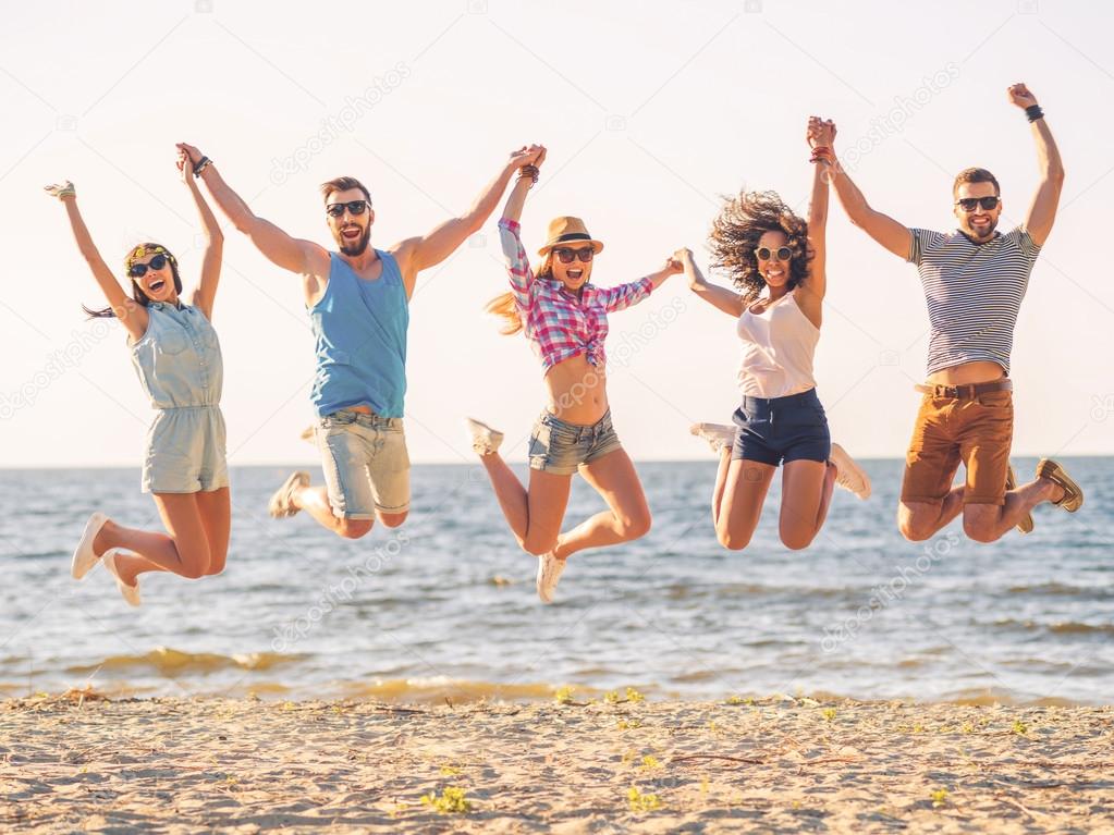 People Jumping On The Sand