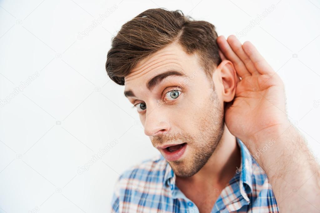 Man holding hand behind ear Stock Photo by ©gstockstudio 76015311