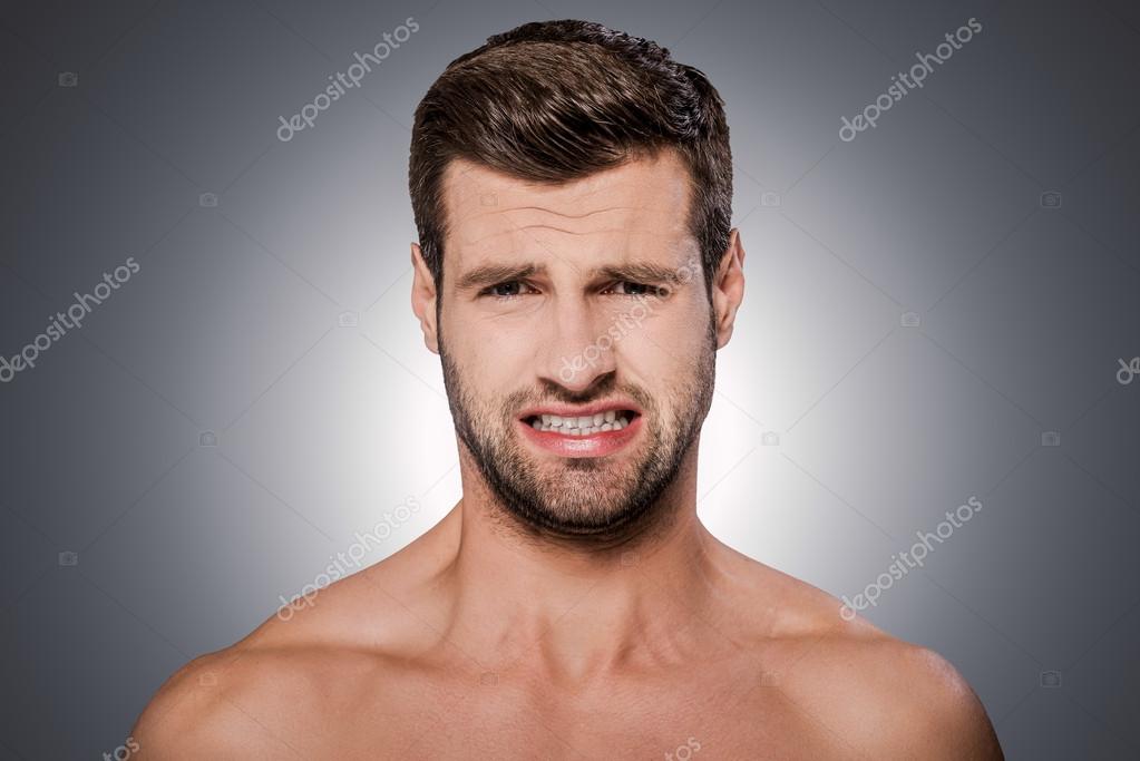 Frustrated young shirtless man Stock Photo by ©gstockstudio 77454114
