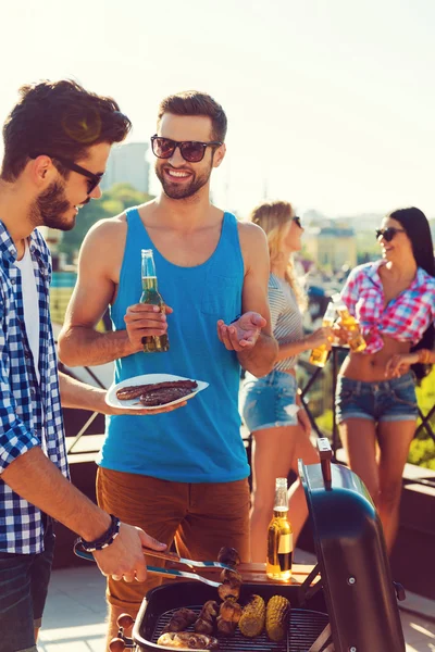 Happy young man barbecuing Stock Photo by ©gstockstudio 80946500