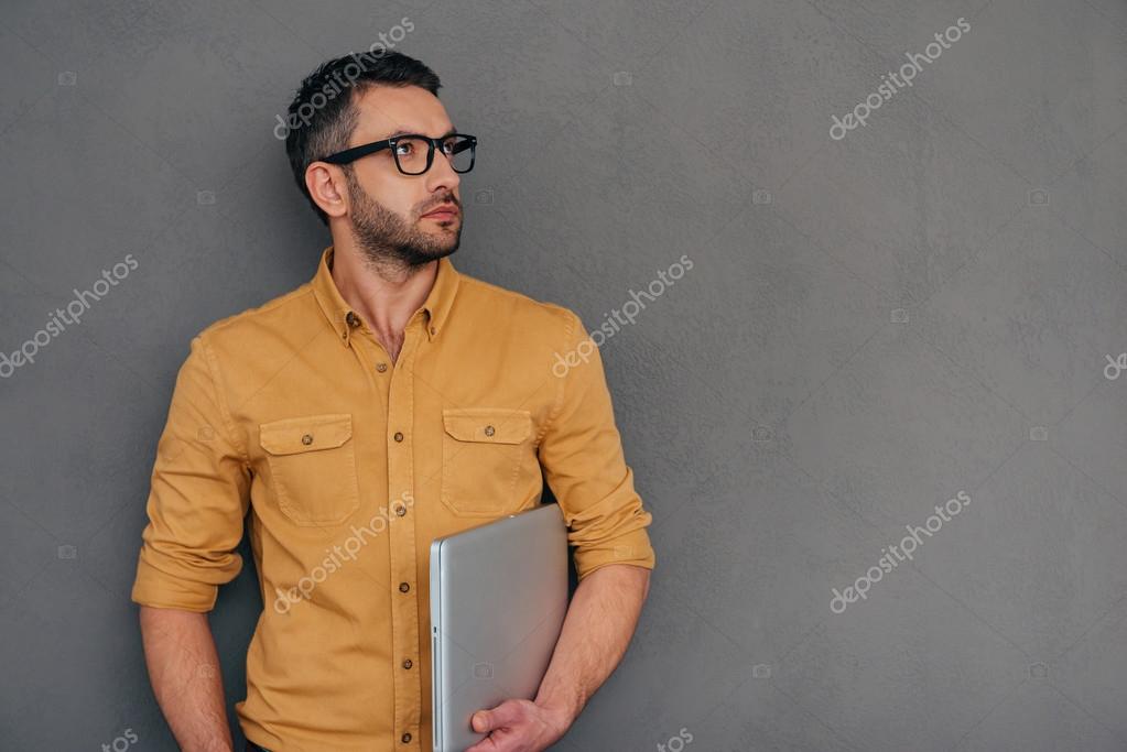 Thoughtful mature man carrying laptop — Stock Photo © gstockstudio ...