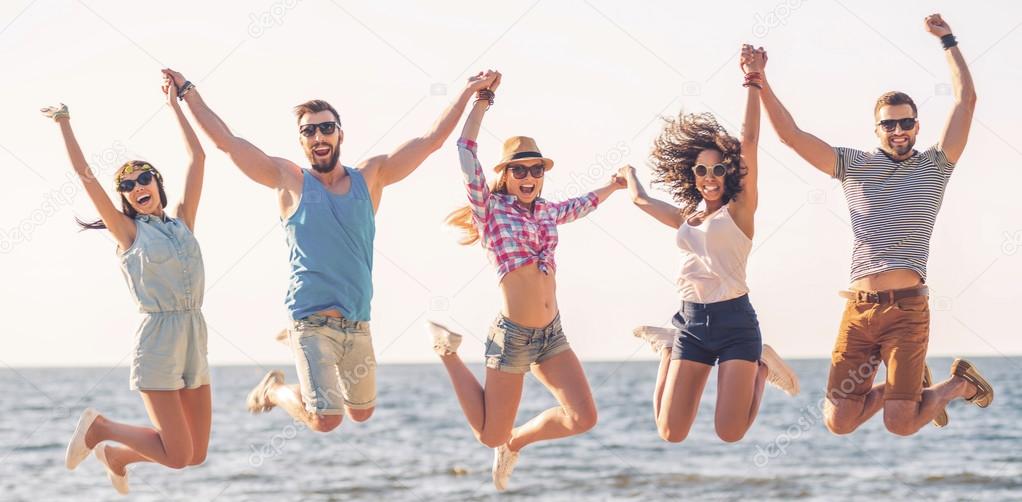 Young people jumping Stock Photo by ©gstockstudio 96644084
